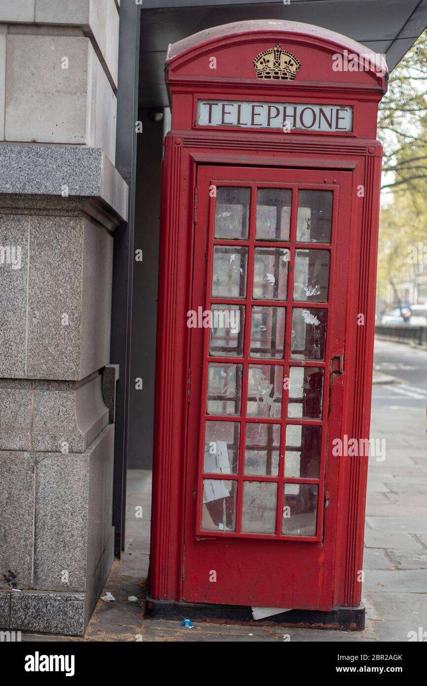 An old red telephone box standing babandoned and in a bad stae Stock ...