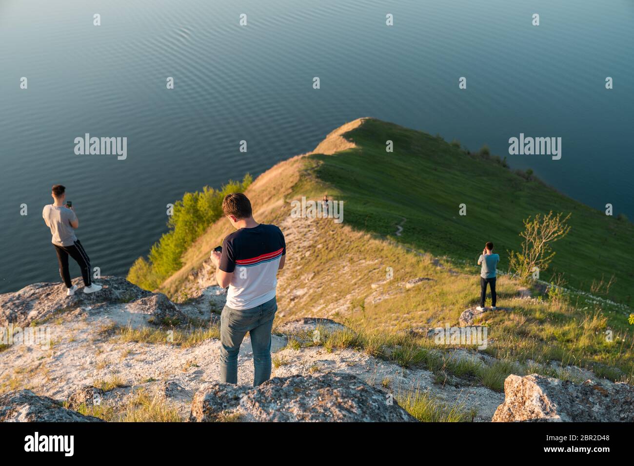 Man standing on cliff ledge hi-res stock photography and images - Alamy
