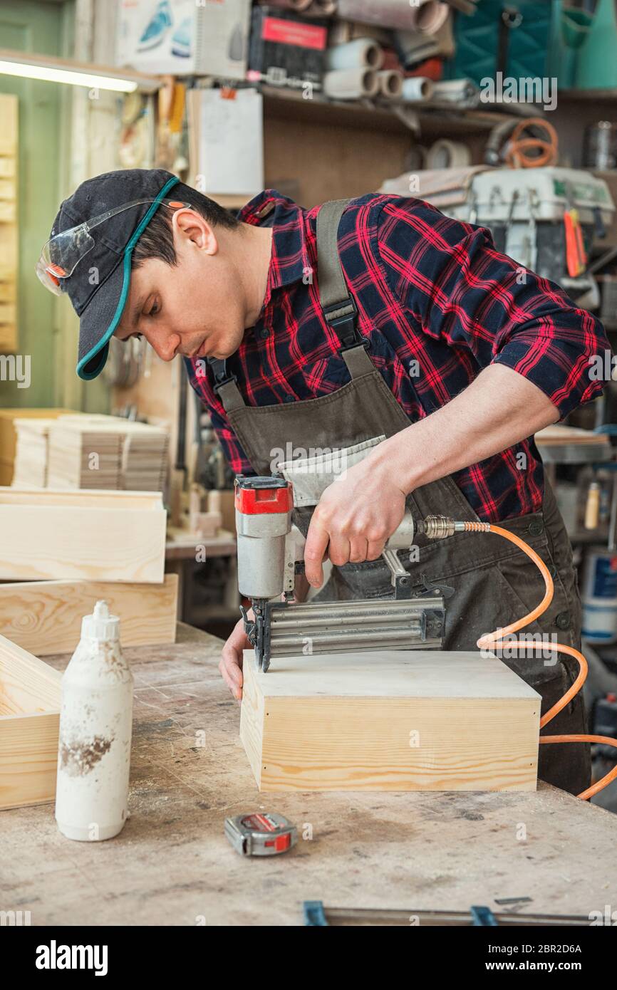 Worker making the wood box. Profession, carpentry and woodwork concept ...