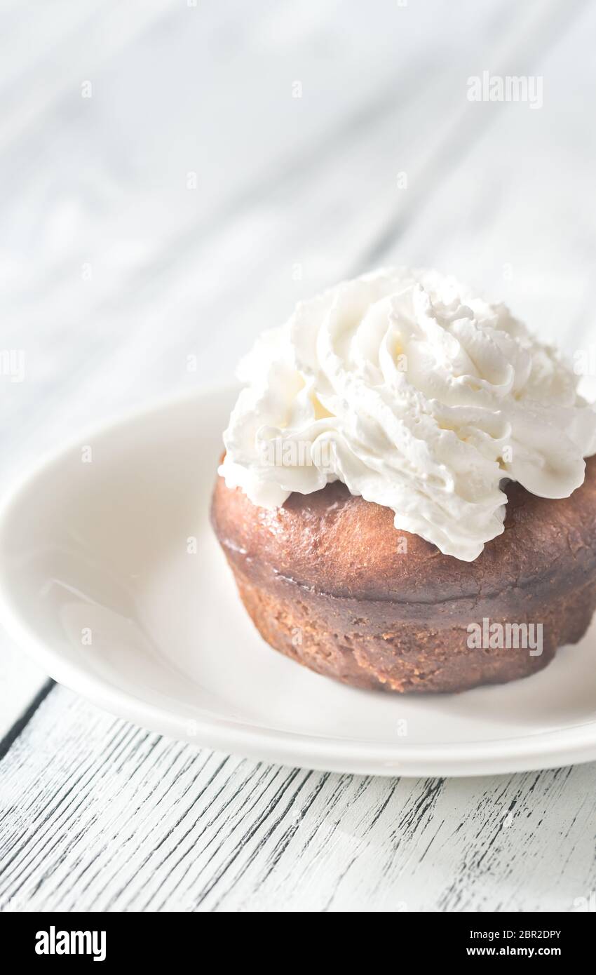 Rum baba decorated with whipped cream on the plate Stock Photo - Alamy