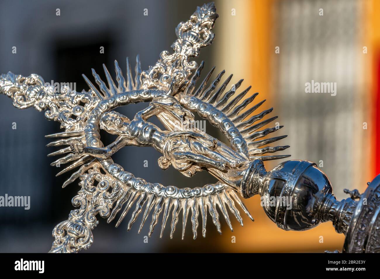 Ornate Jesus ornament at the end of a long pole carried by a priest in ...