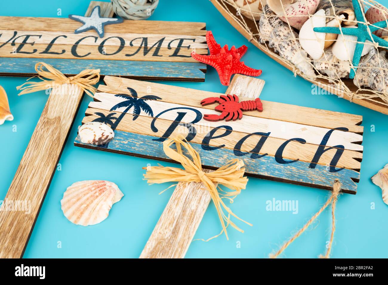 Wooden signs welcome beach and shells on blue background Stock Photo ...