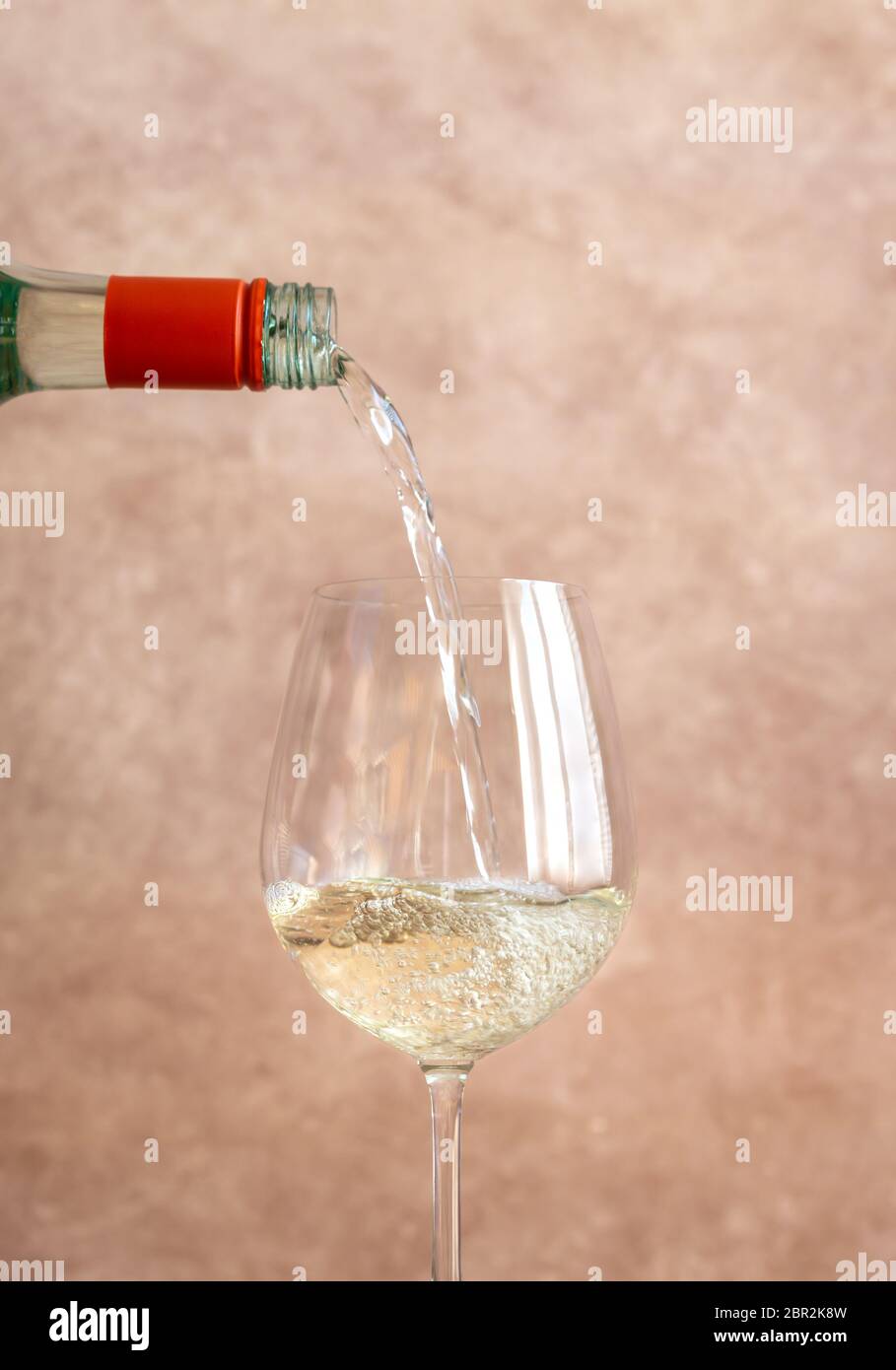 White wine pouring into glass close-up Stock Photo - Alamy