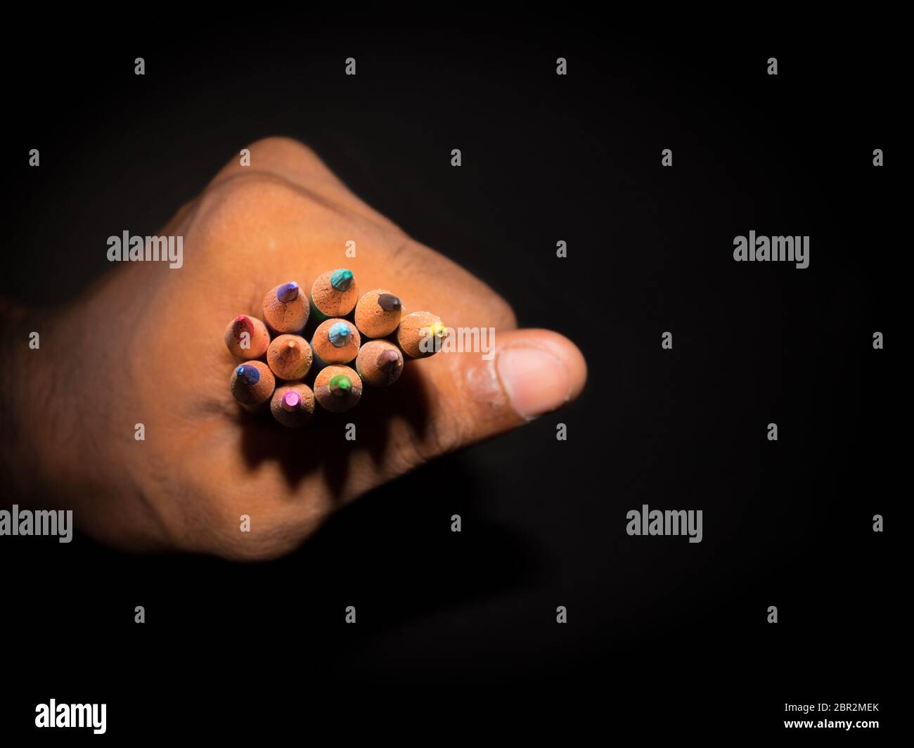 Human hand close up of a young artist holding showing colorful office ...