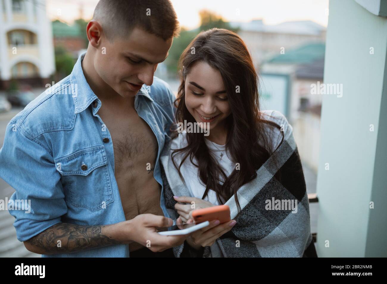 Standing on the balcony, using phones. Quarantine lockdown, stay home ...