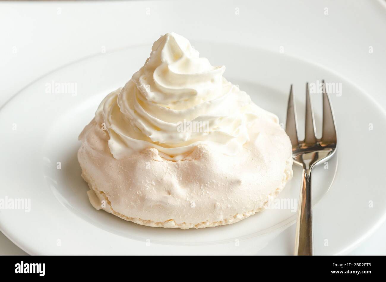 Meringue cake with whipped cream and berry topping Stock Photo - Alamy