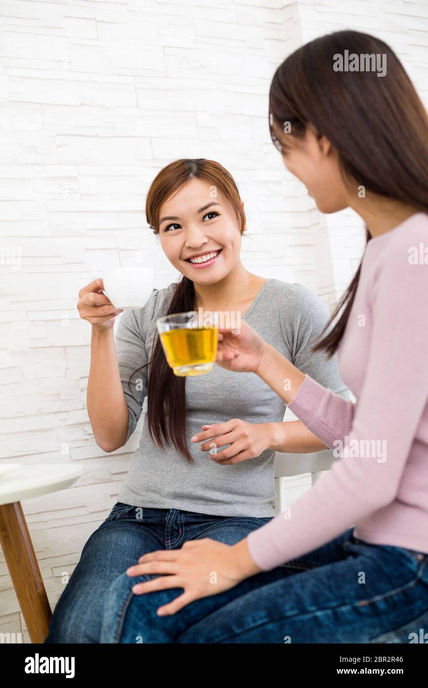 Two young Woman drinking of tea Stock Photo - Alamy