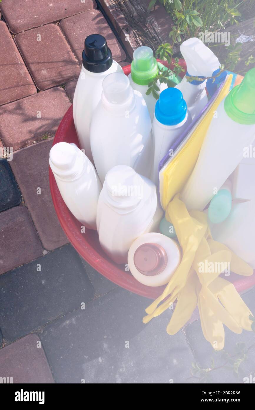 Cleaning supplies, group of colorful plastic bottles outdoor, Basket ...
