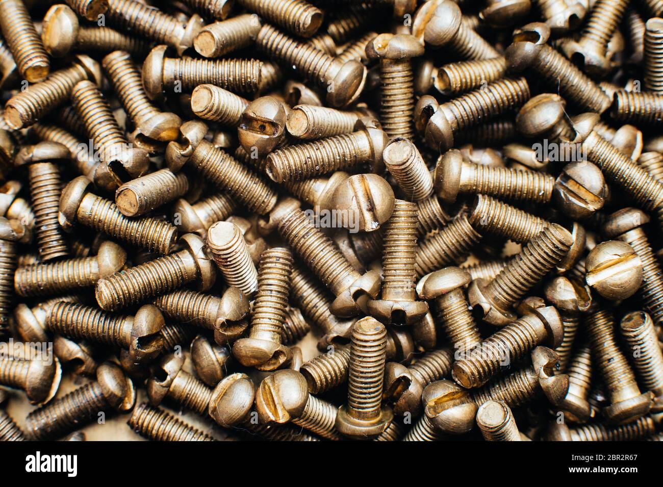 Close-up, macro. Old Soviet brass pan head screw with a flat head ...