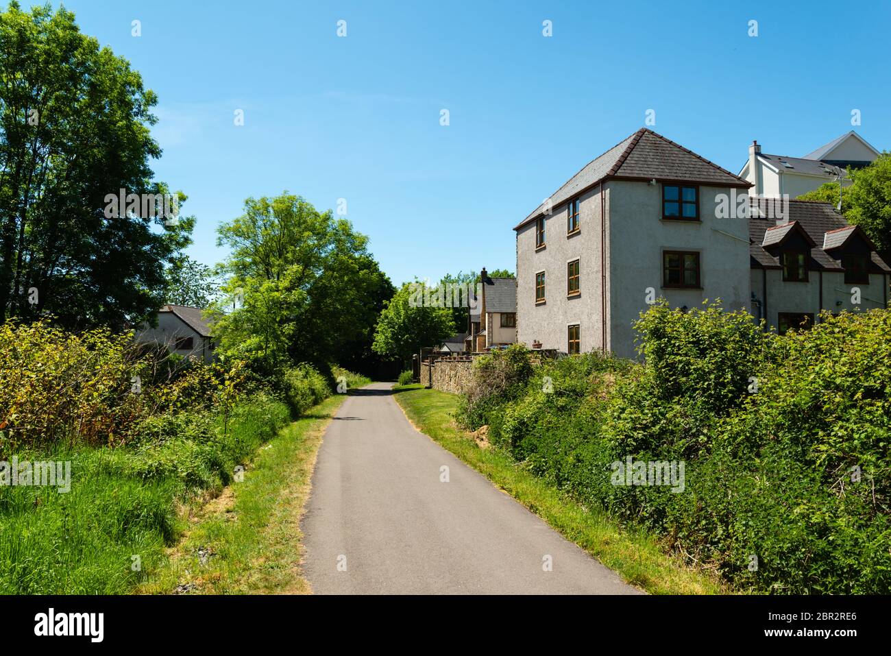 House and hedges alongside national cycle route 4 Stock Photo - Alamy