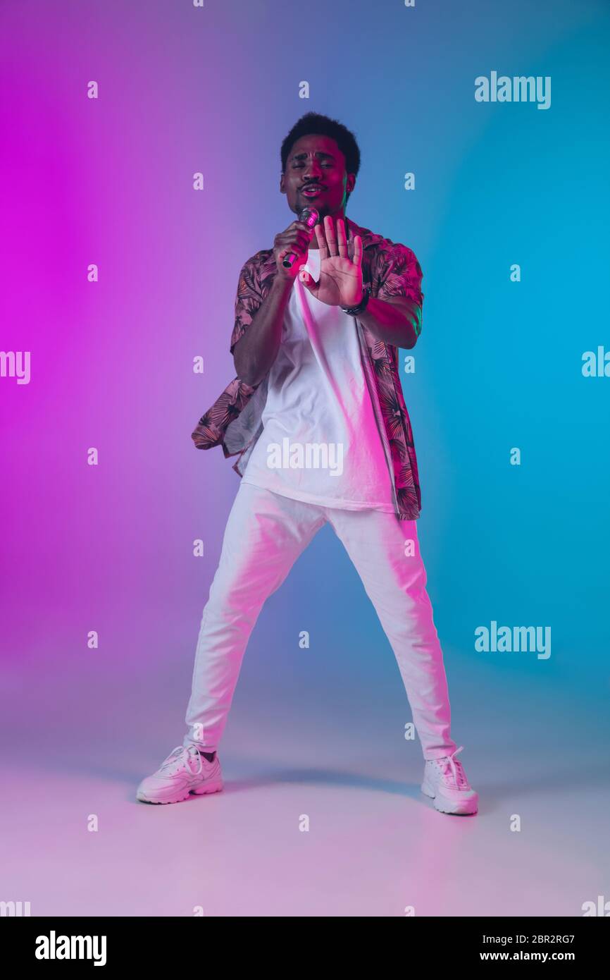 African-american male singer portrait isolated on gradient studio ...