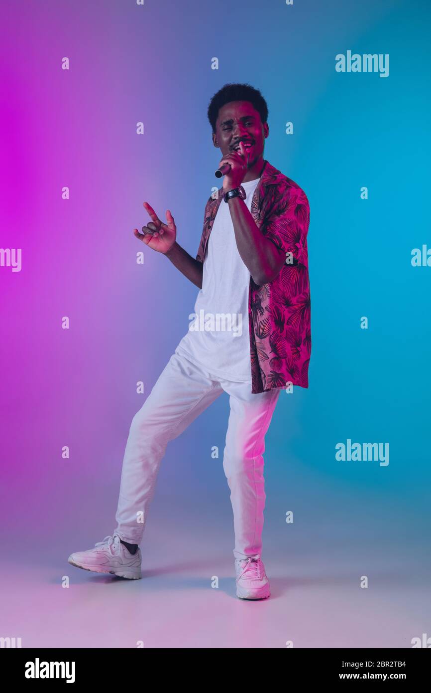 African-american male singer portrait isolated on gradient studio ...