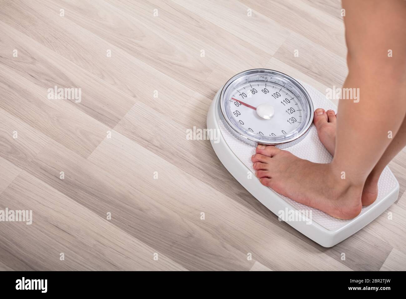 Low Section Of Woman Foot On Weighting Scale At Home Stock Photo - Alamy