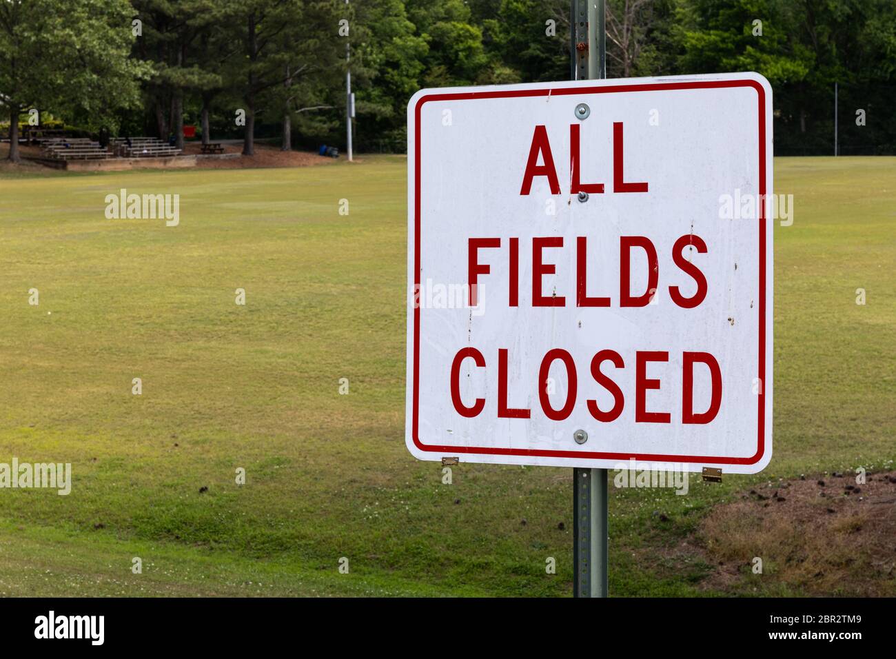 All Fields Closed sign by an empty soccer field, coronavirus shutdown ...