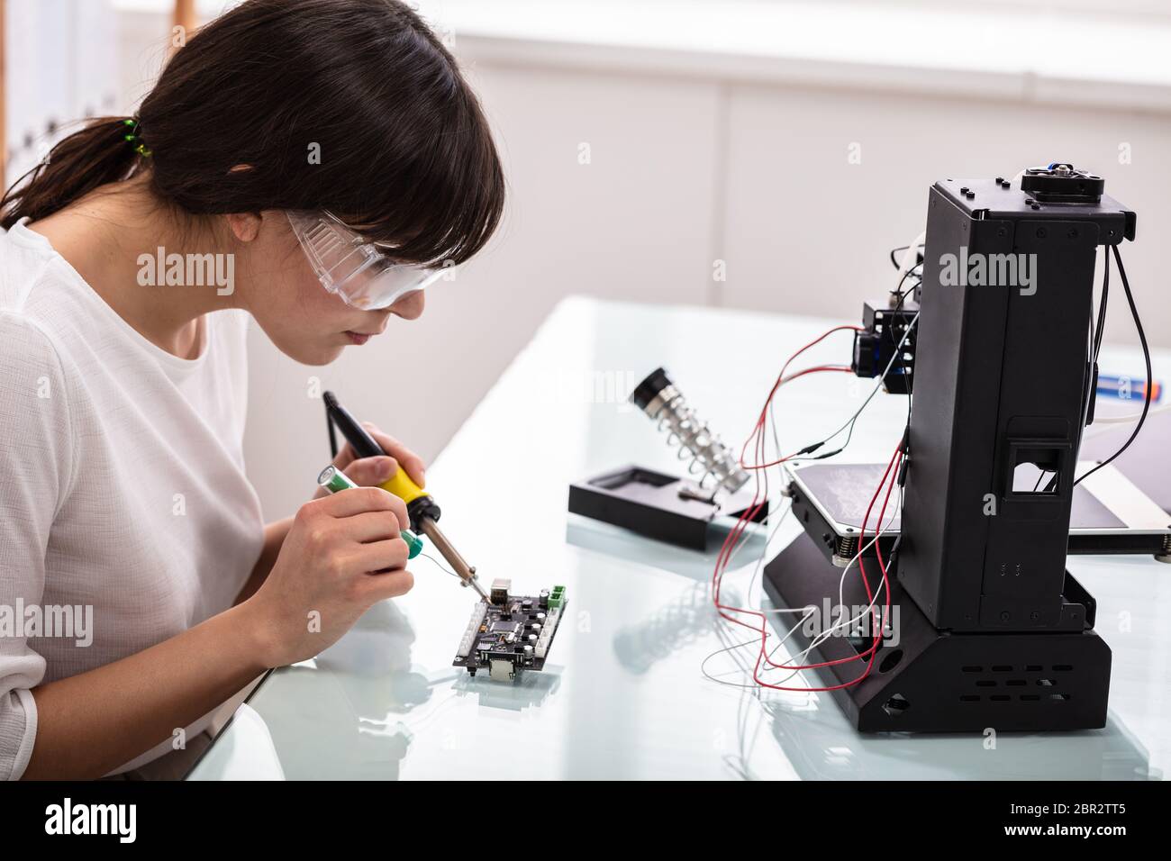Female Engineer Or Tech Repairs Electronic Device In Hardware Repair ...