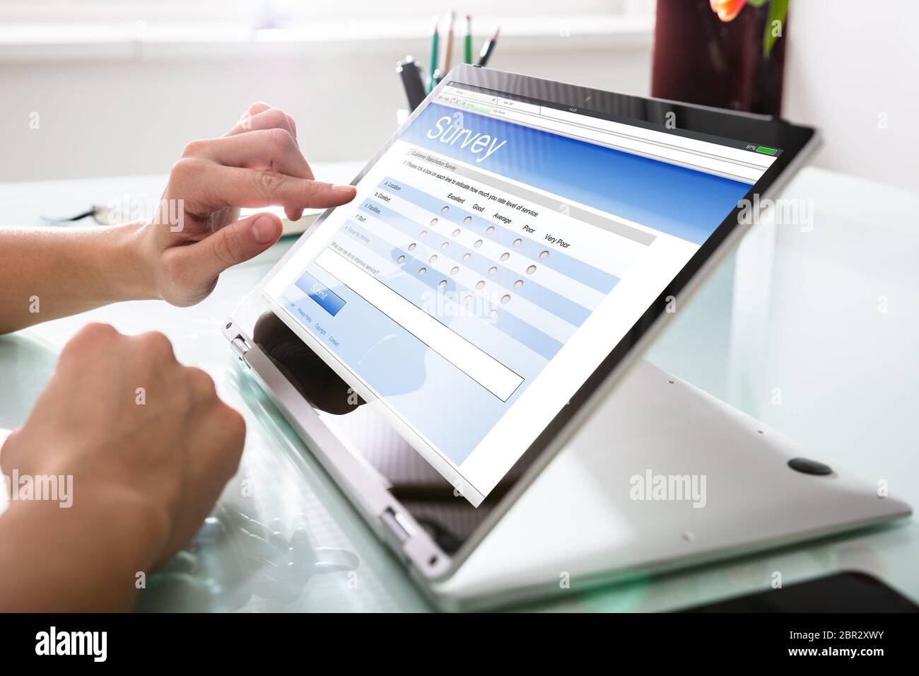 Close-up Of A Businessperson's Hand Filling Online Survey Form On ...