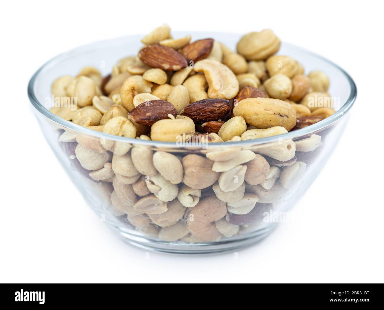 Portion of roasted nuts isolated on white background as close up shot ...