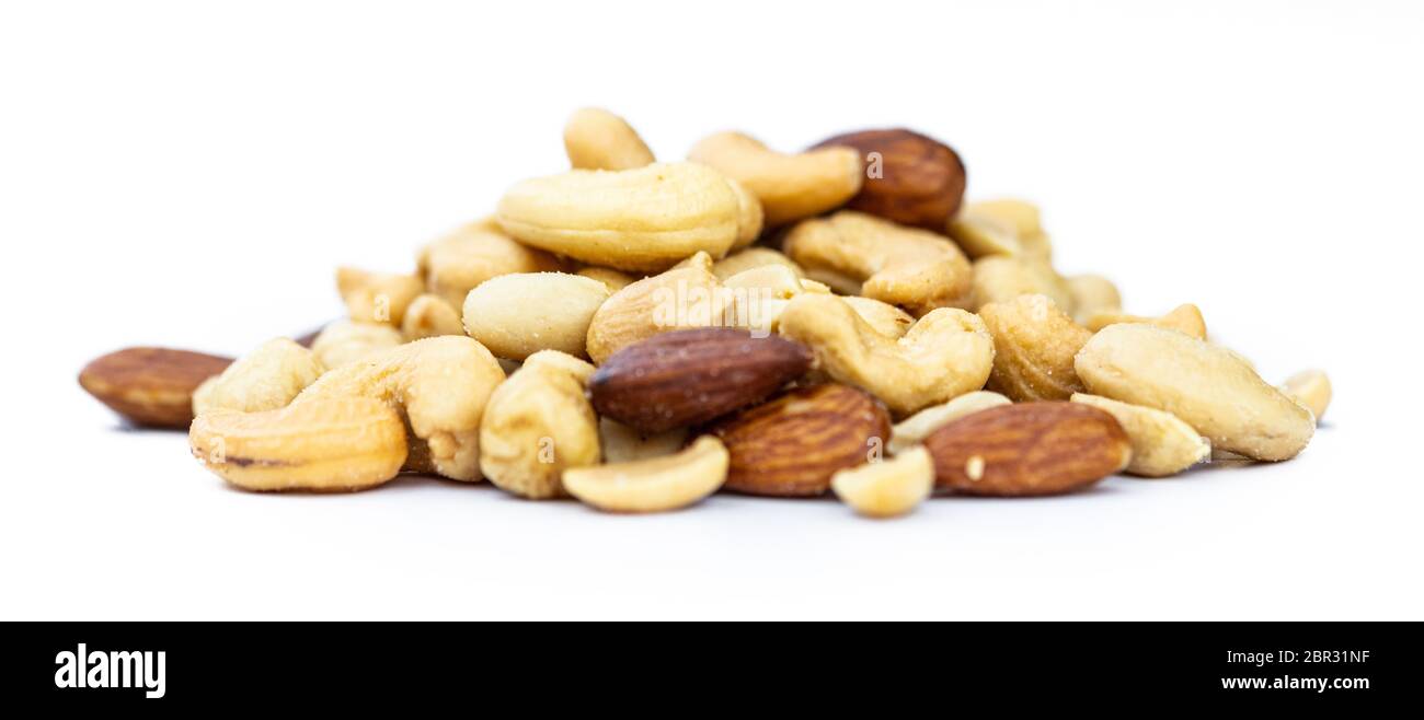 Fresh roasted nuts isolated on white background as close up shot ...