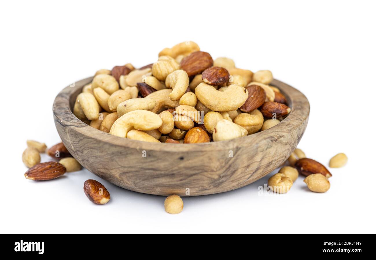 Portion of roasted nuts isolated on white background as close up shot ...