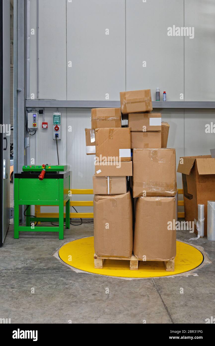 Pallet With Boxes at Wrapping Machine in Warehouse Stock Photo - Alamy