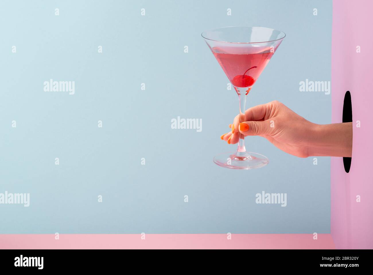 Woman's hand holding a glass of red prosecco Stock Photo - Alamy
