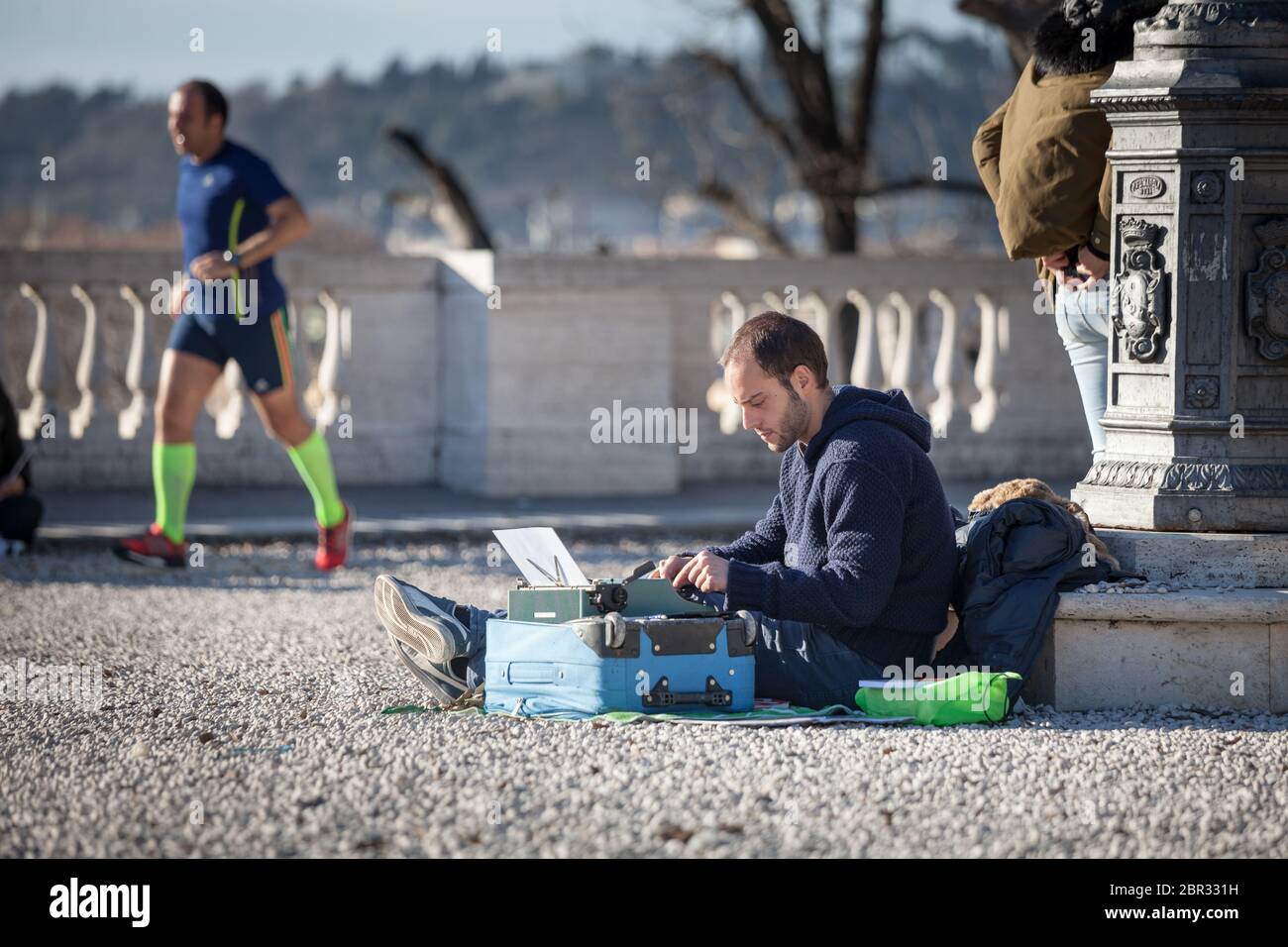 Rome, Italy. January 10, 2016: A young man is sitting down and writing ...