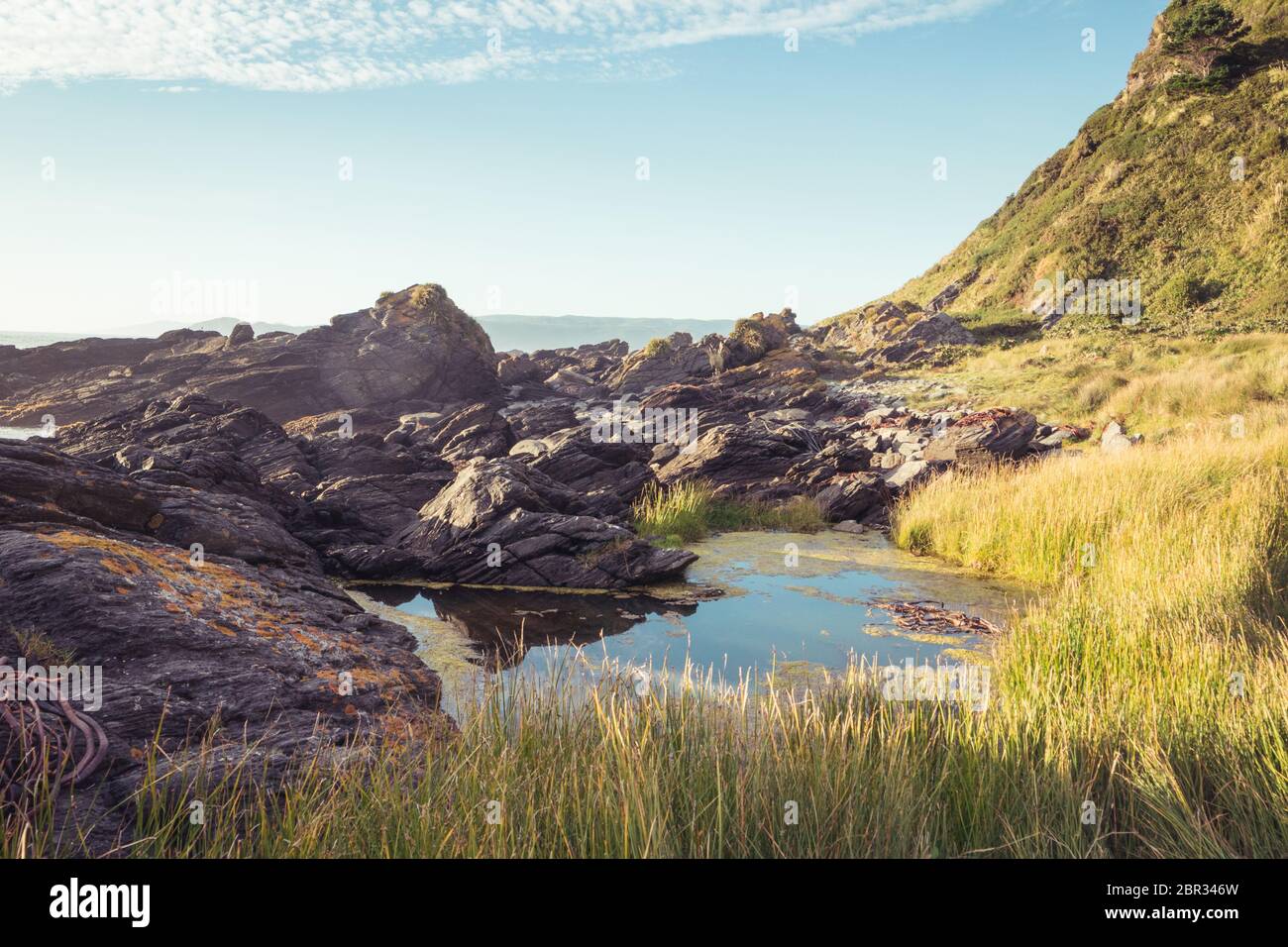 Beautiful sunset in the rocks in a small beach located at the south of ...