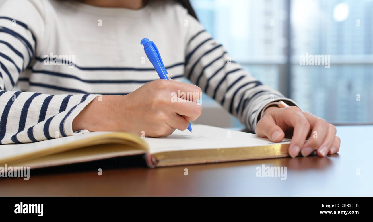 Woman write on the book Stock Photo - Alamy