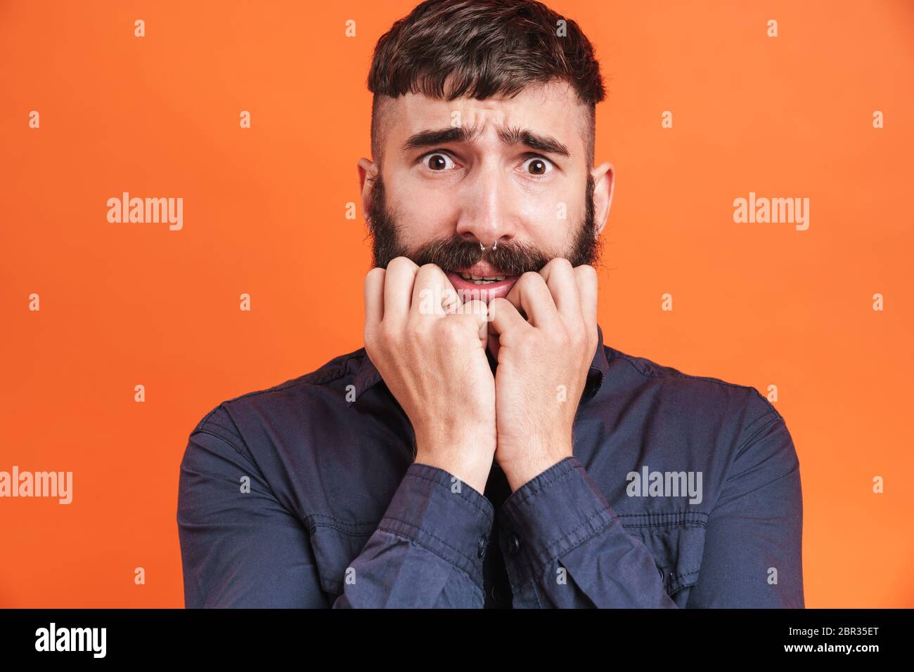 Image closeup of uptight man with nose jewelry wearing black shirt ...