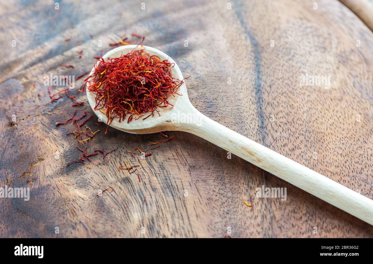 Saffron on the wooden spoon Stock Photo - Alamy
