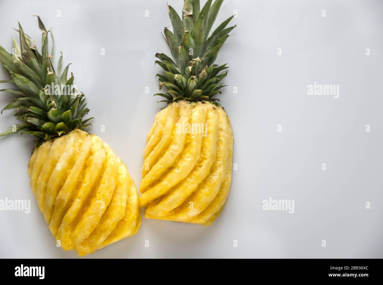 Pineapple on the white background: cross section Stock Photo - Alamy