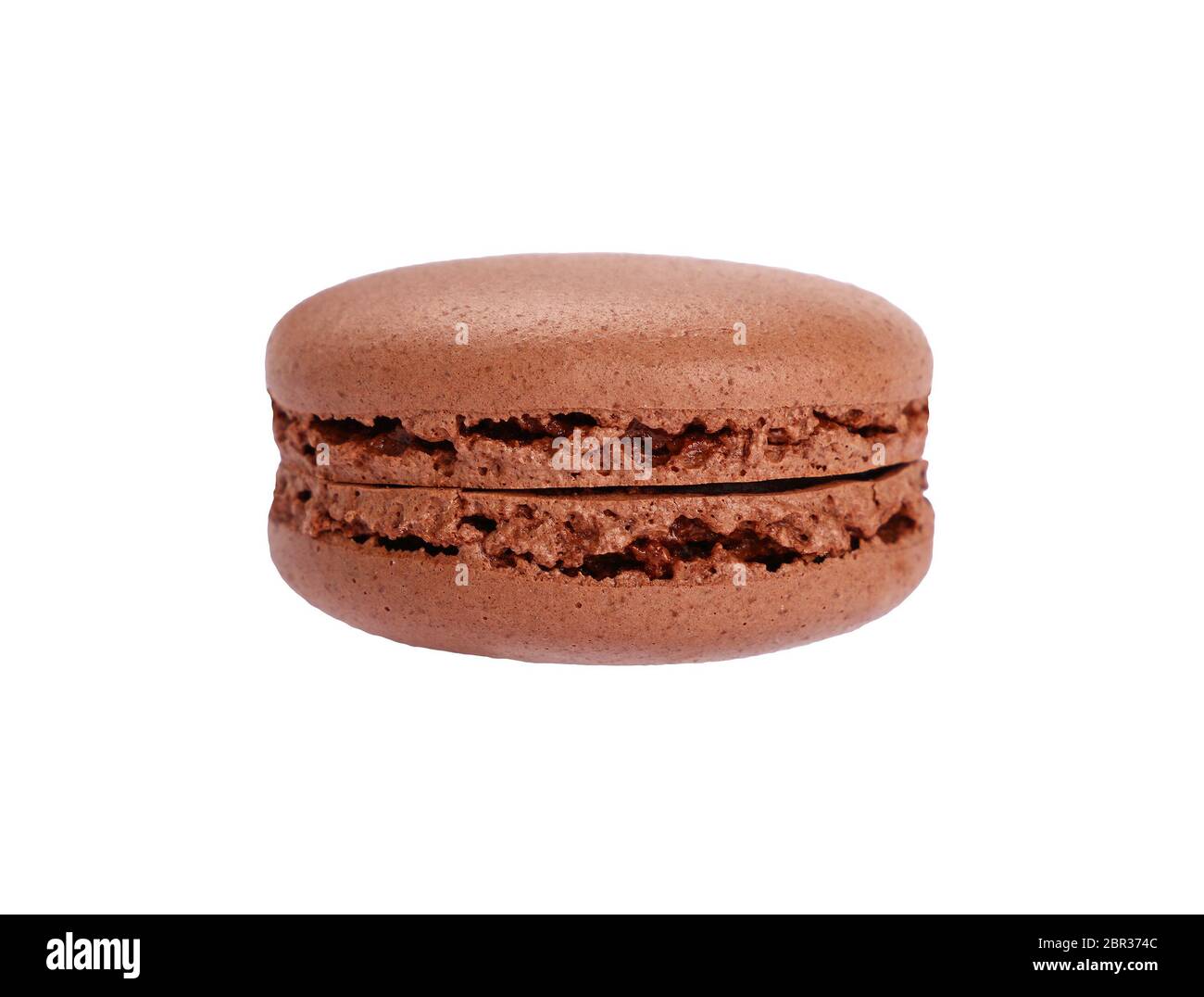 Close up one fresh brown chocolate traditional French macaroon pastry ...