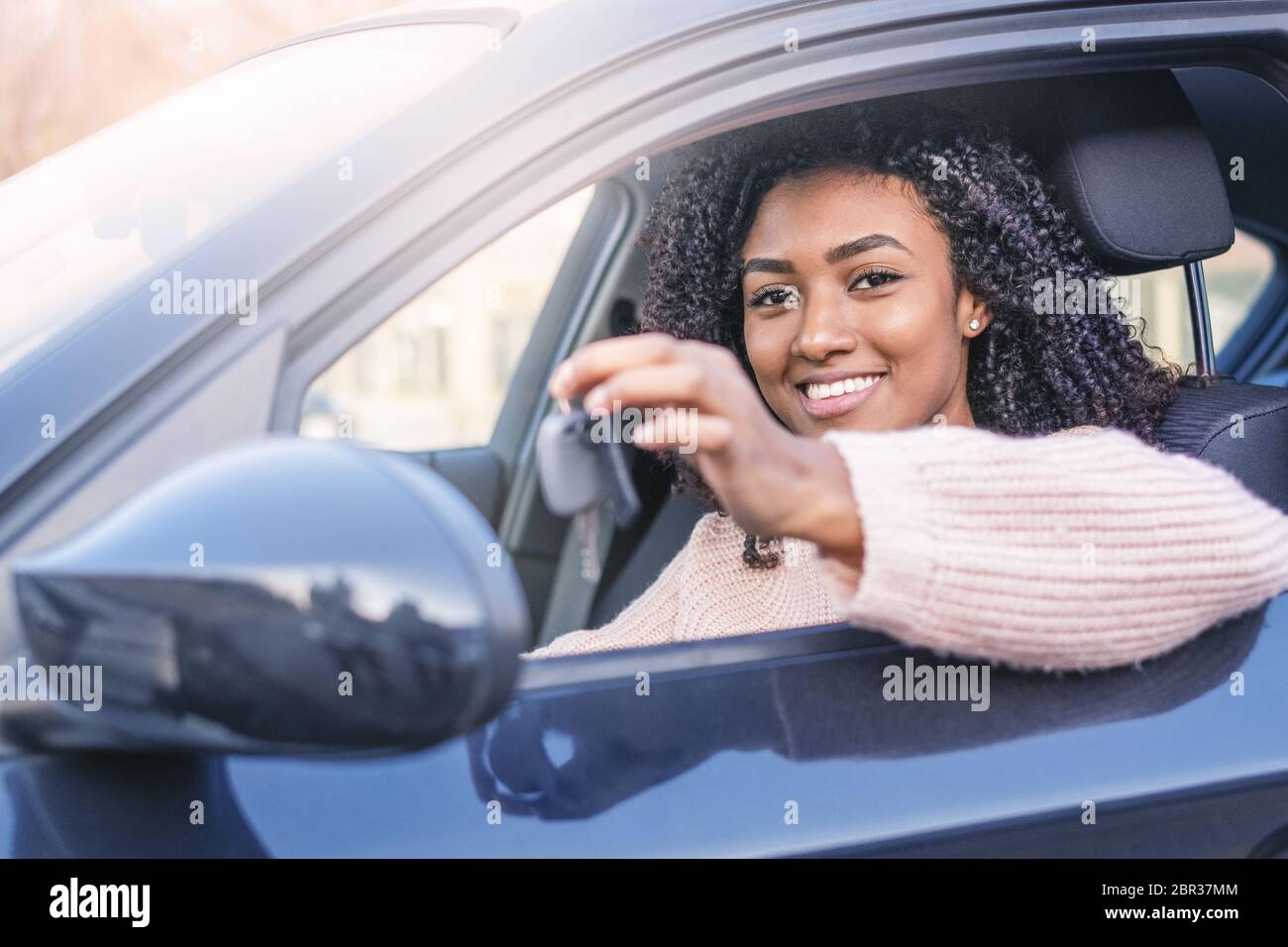 Young black woman driving hi-res stock photography and images - Alamy