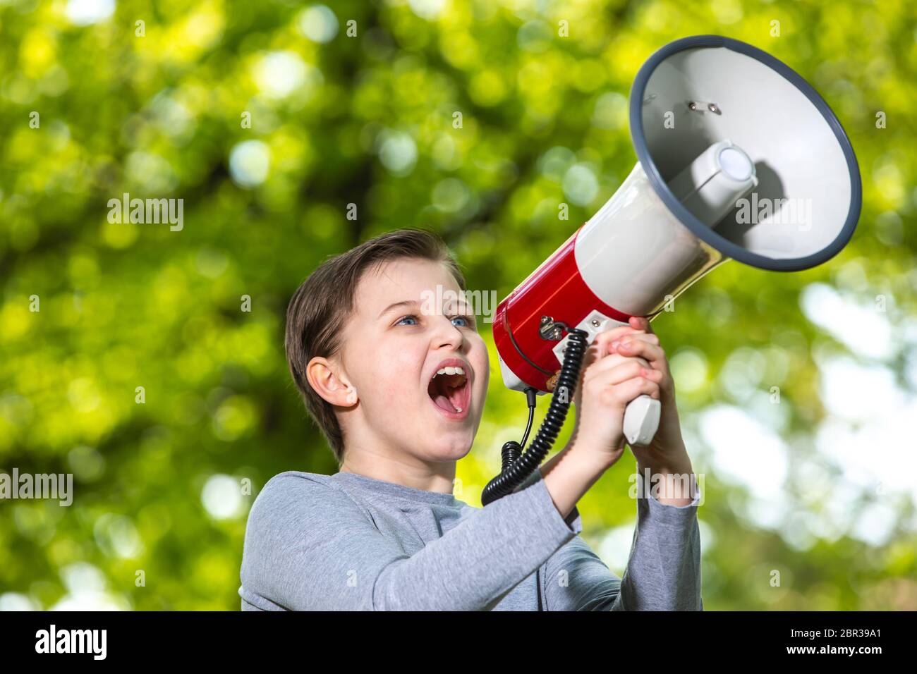 Kid shouting through megaphone hi-res stock photography and images - Alamy