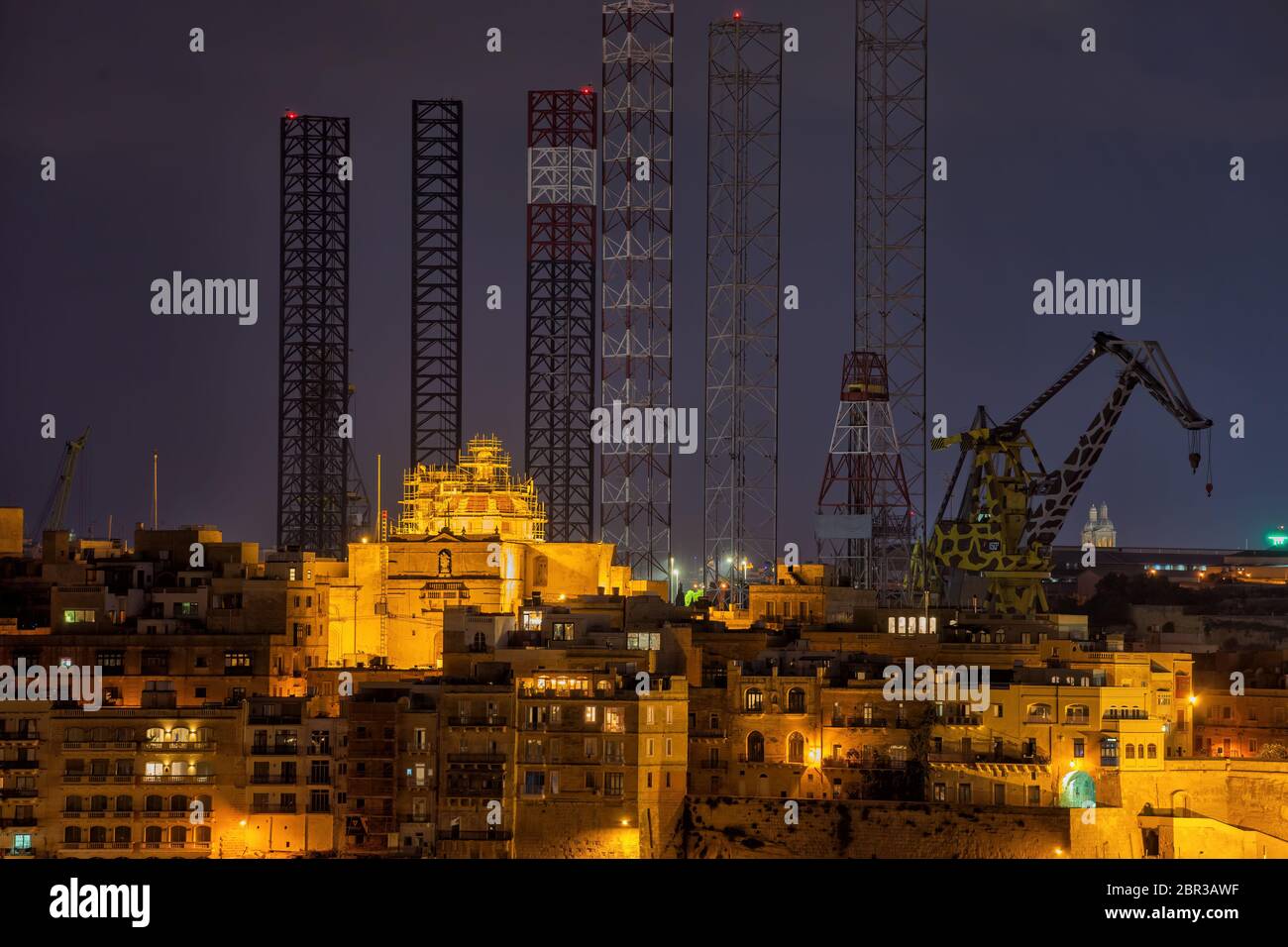 Senglea city skyline and shipyard cranes at night in Malta Stock Photo ...