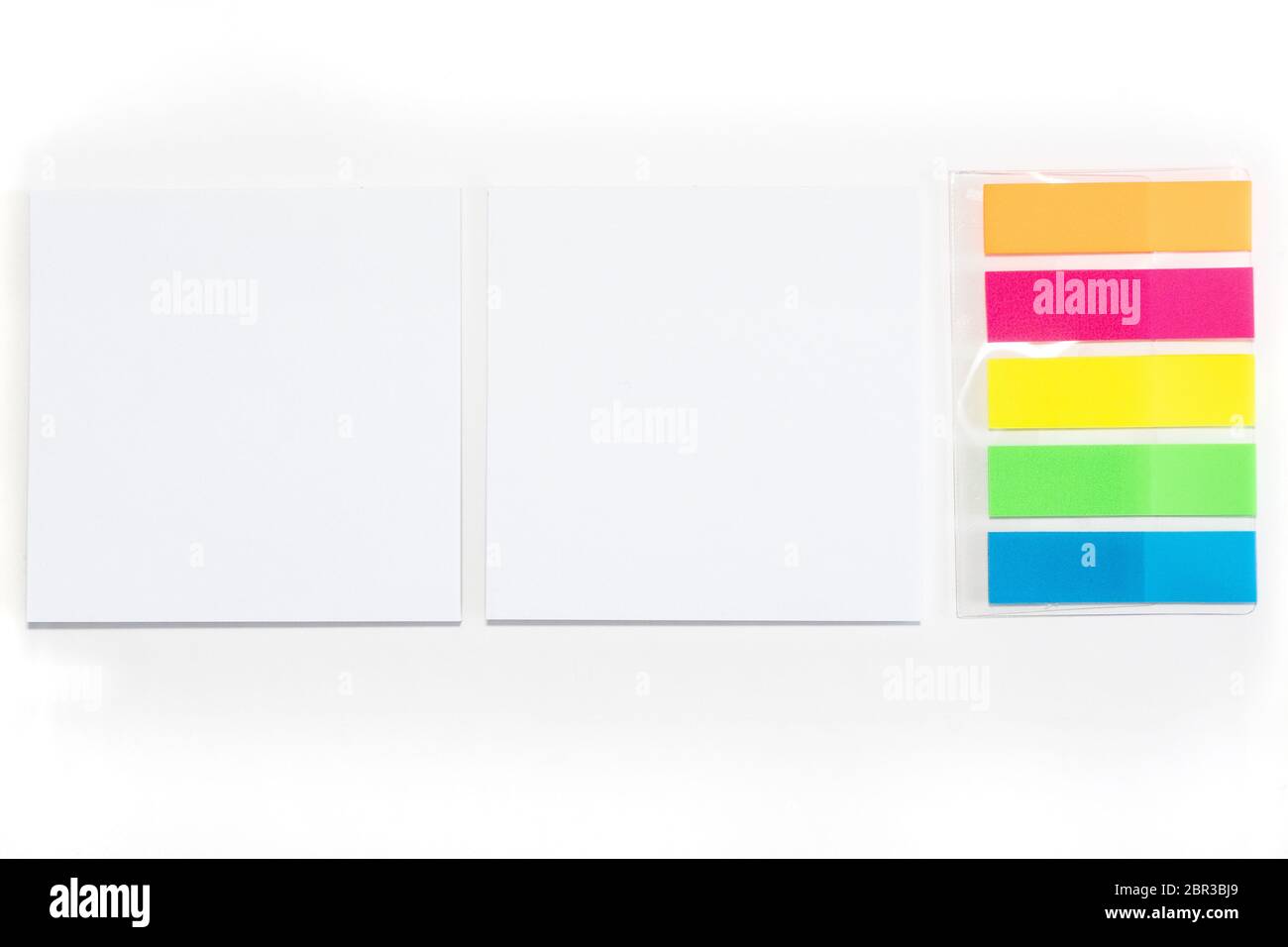 Two White sticky note and different colored sheets of note papers ...