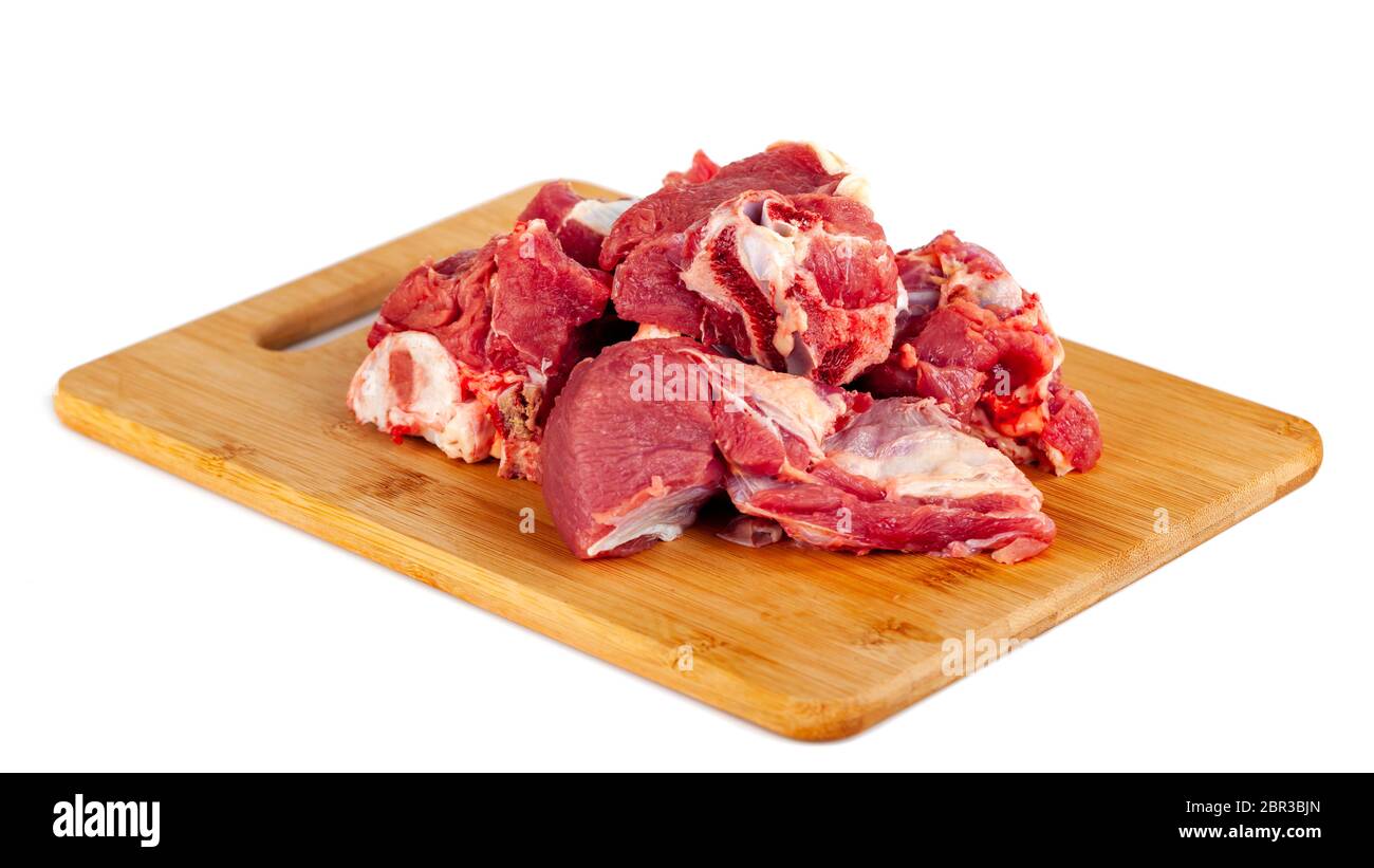 Chopped raw meat on wooden board isolated on white background Stock ...