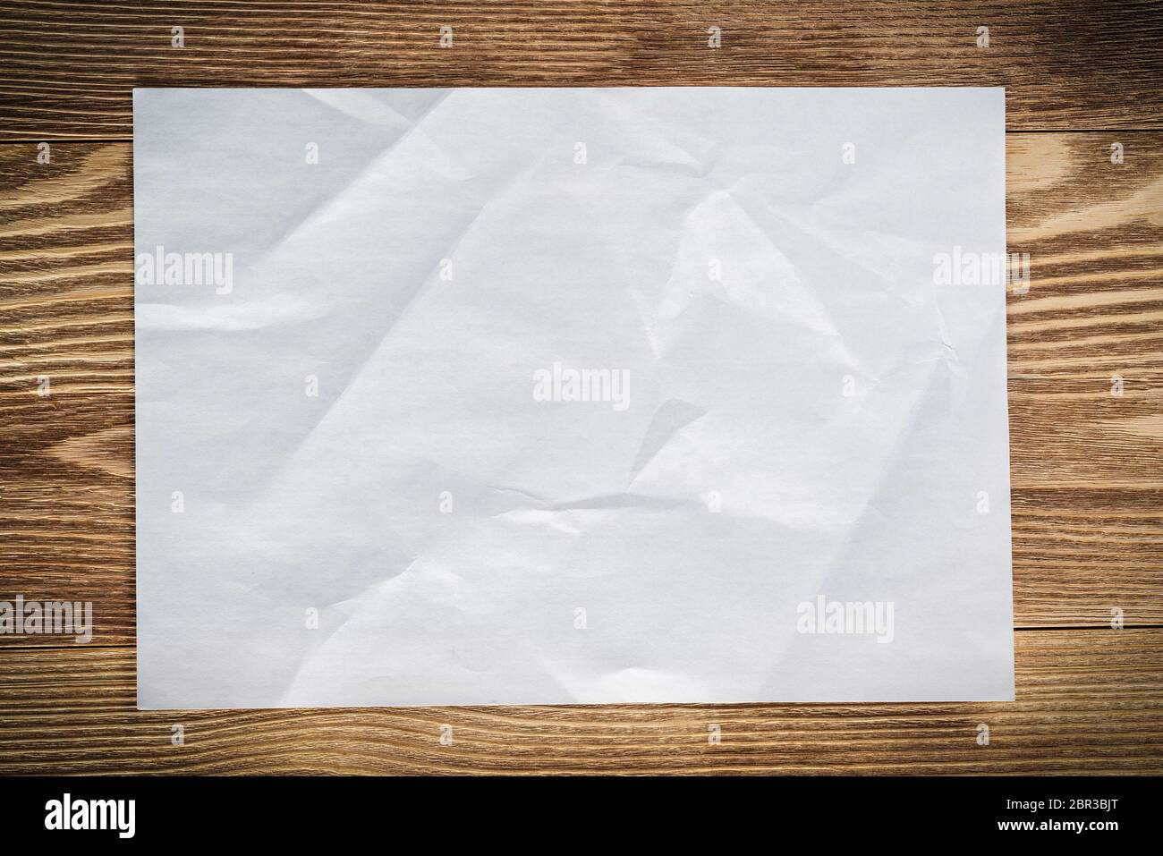 Flat lay wooden table with paper sheet Stock Photo - Alamy