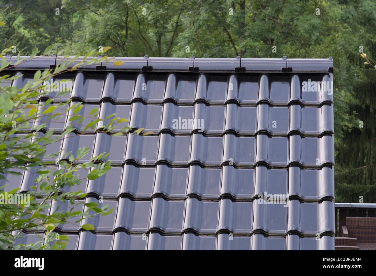 Modern roof with PVC coated black roof tiles with brick effect Stock ...