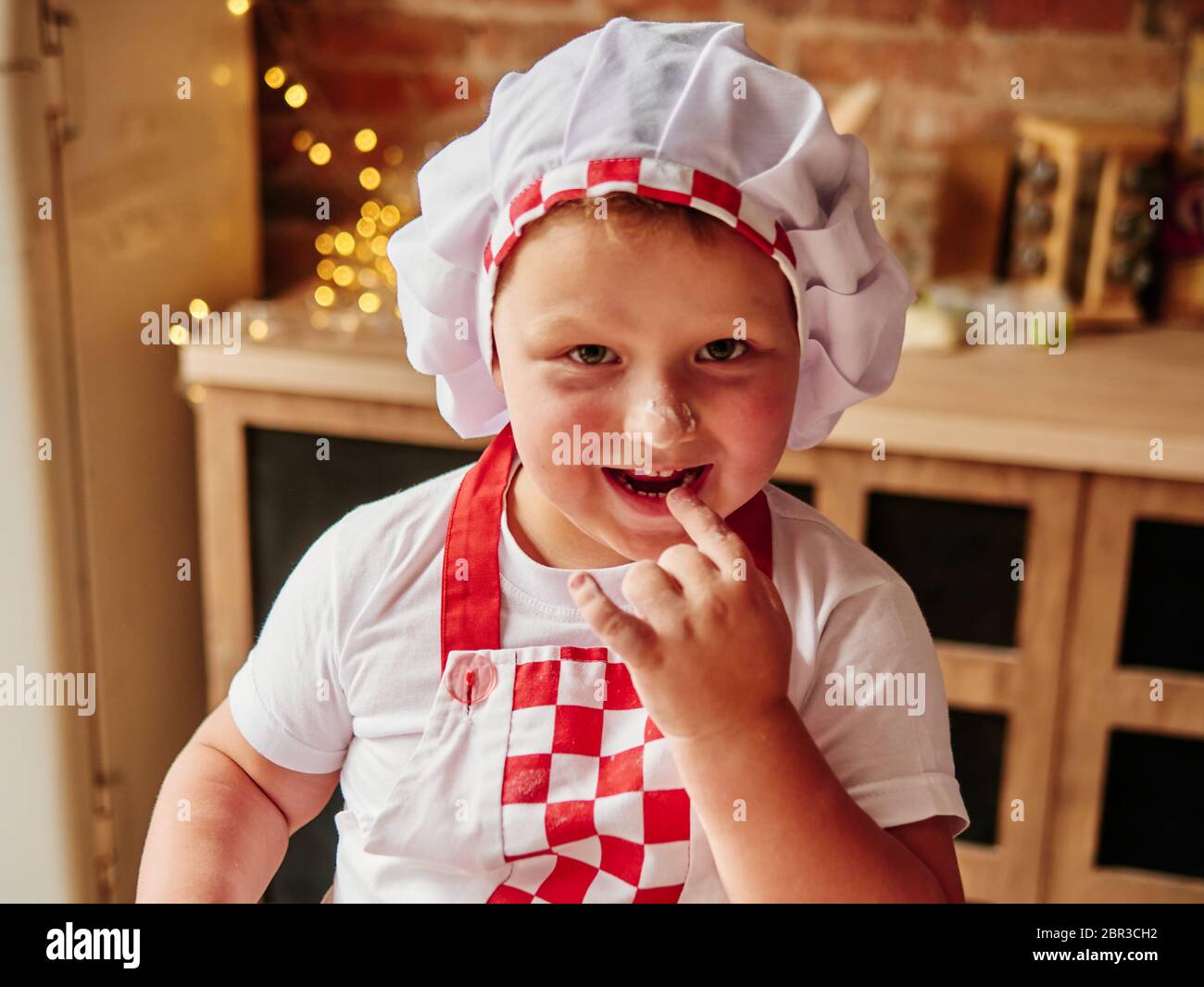 Little fatty boy at domestic kitchen. Happy family, happy kids concept ...