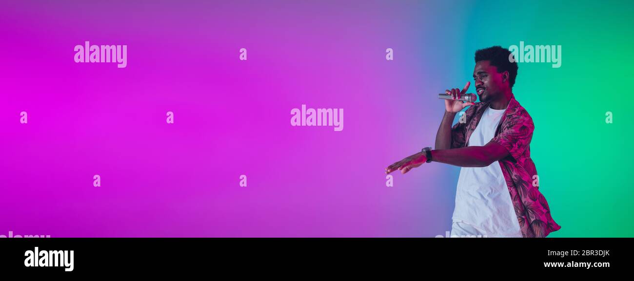 African-american male singer portrait isolated on gradient studio ...