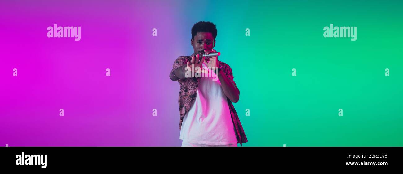 African-american male singer portrait isolated on gradient studio ...