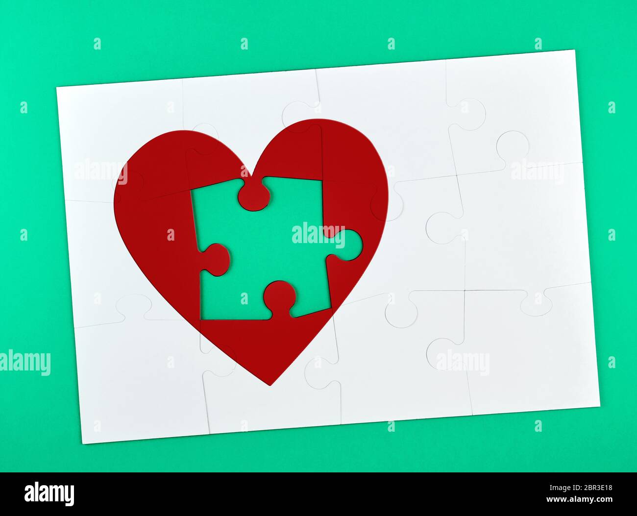 white big puzzles, one element from the red heart shape is missing ...