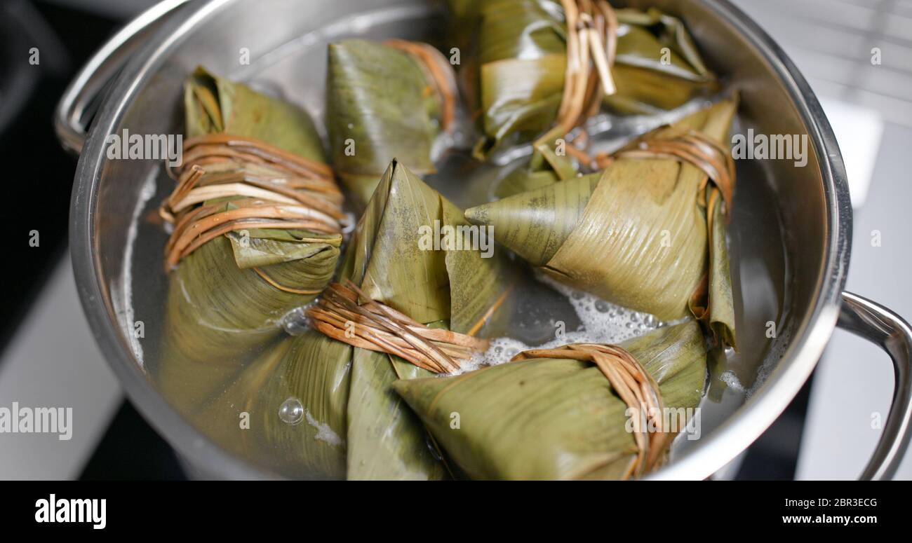 Cooking stick rice bamboo dumpling Stock Photo - Alamy