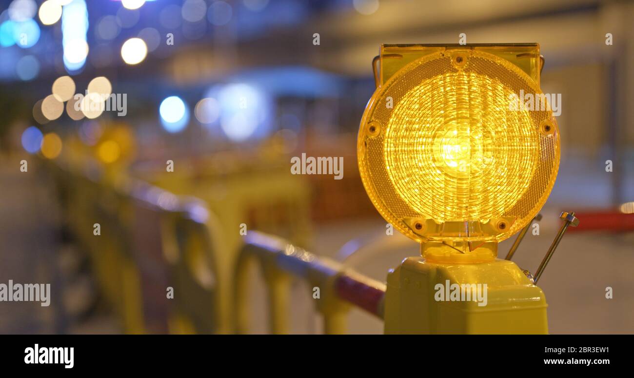 Yellow caution light in the street at night Stock Photo - Alamy