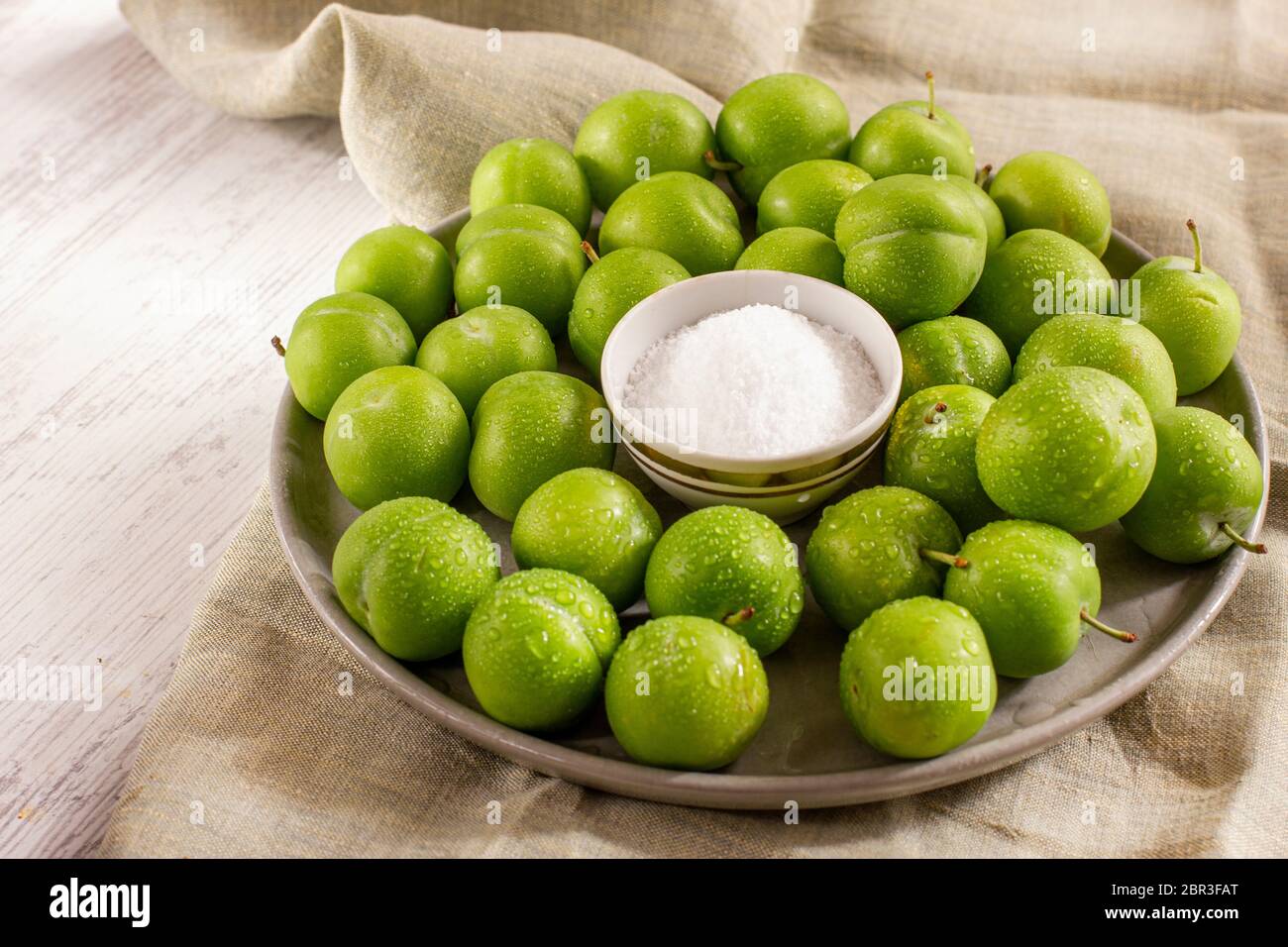Unripe sour green plums with salt. Traditional turkish snack Stock ...