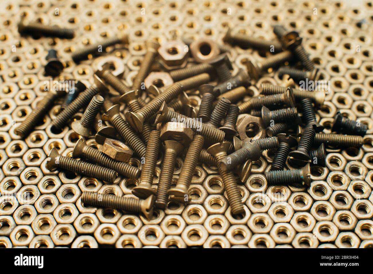 Close-up, macro. Old Soviet brass countersunk head screws with a flat ...