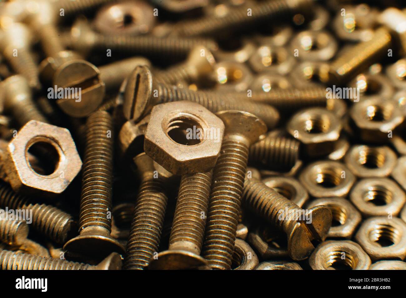 Close-up, macro. Old Soviet brass countersunk head screws with a flat ...