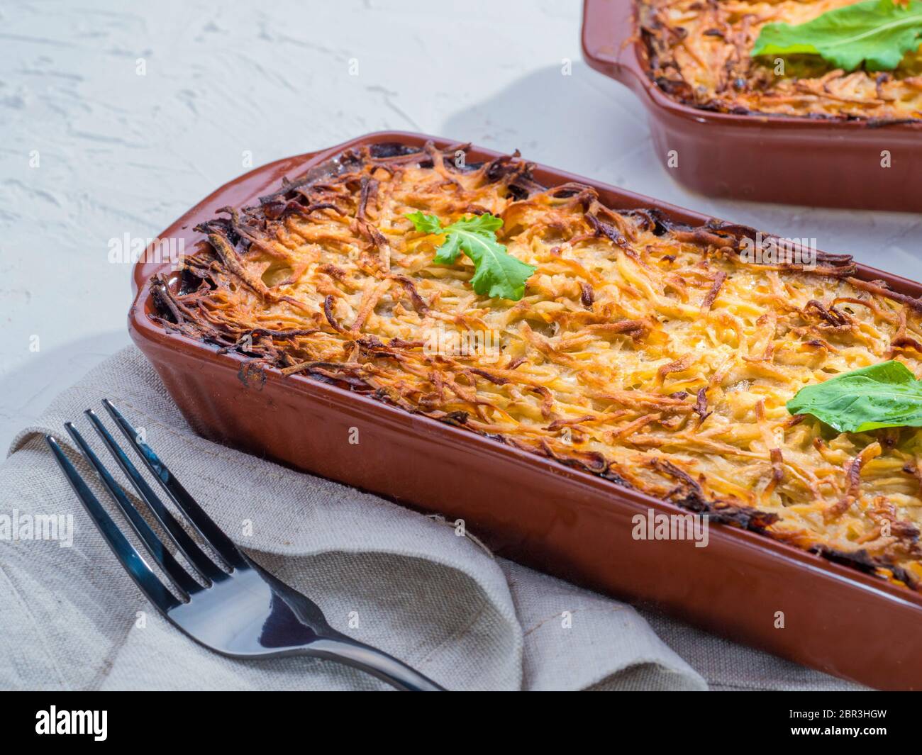 Close up view of appetizing potato casserole with fish, eggs and cream ...