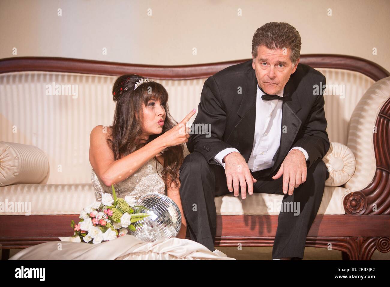 Upset bride pointing at new husband Stock Photo - Alamy